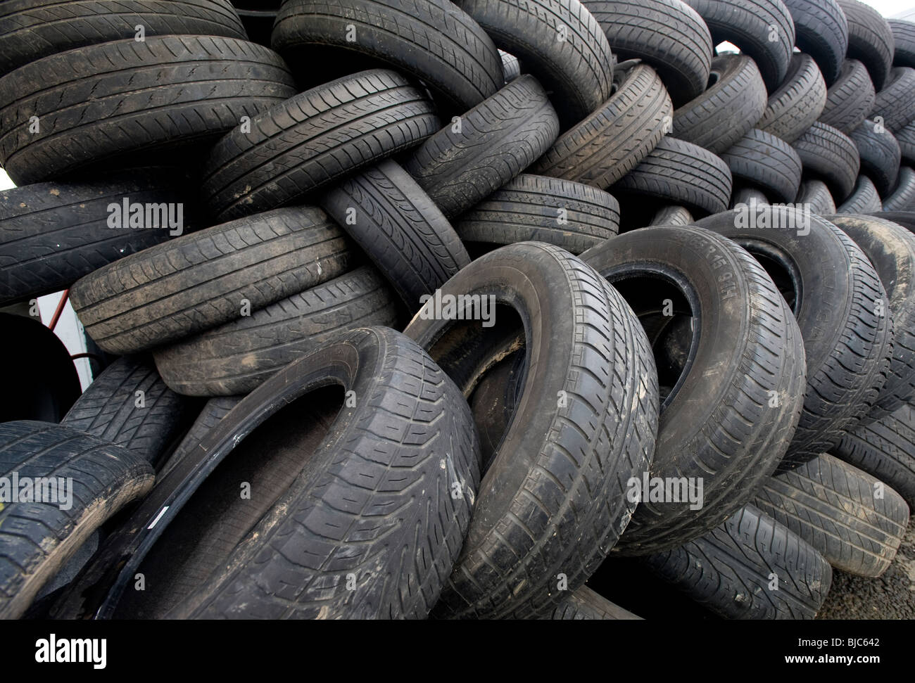 Waste car tyres stacked up in a pile waiting to be recycled Stock Photo ...