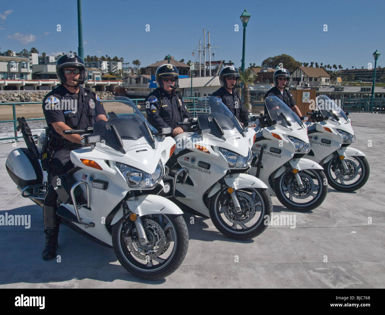 Beach motorcycle police officers sit astride their motors for law ...