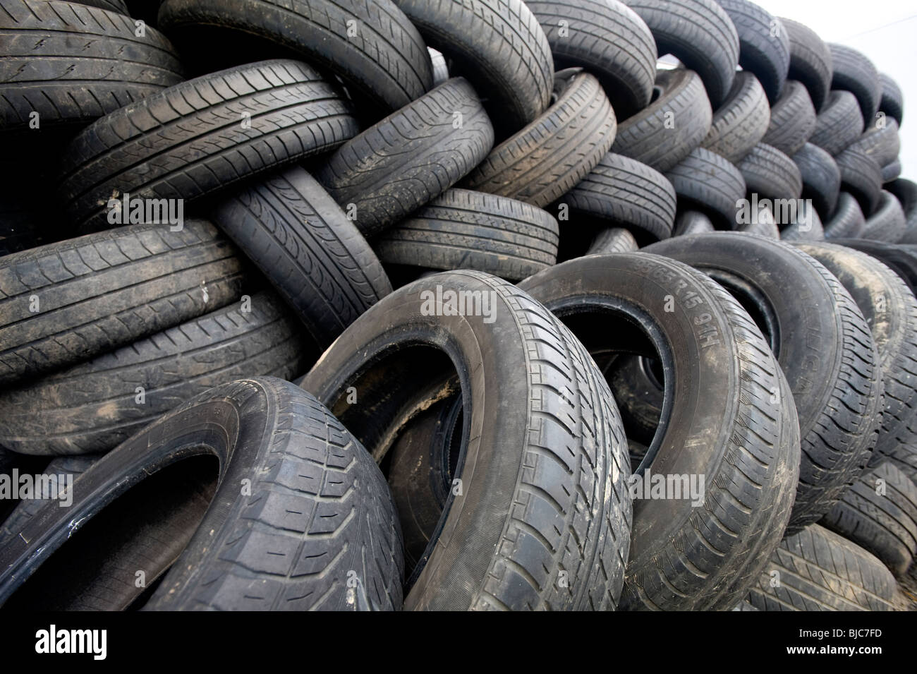 Waste car tyres stacked up in a pile waiting to be recycled Stock Photo ...