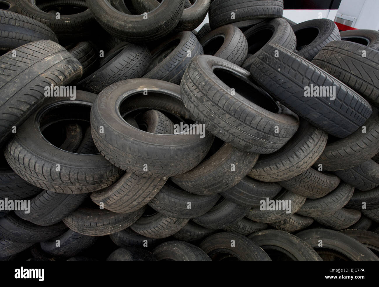 Waste car tyres stacked up in a pile waiting to be recycled Stock Photo ...