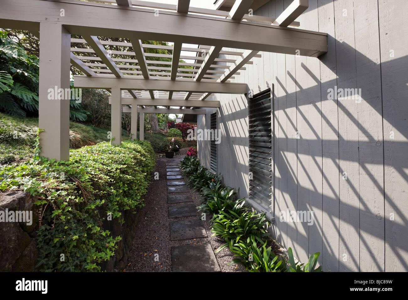 Trellis over walkway into custom luxury home in Hawaii Stock Photo - Alamy