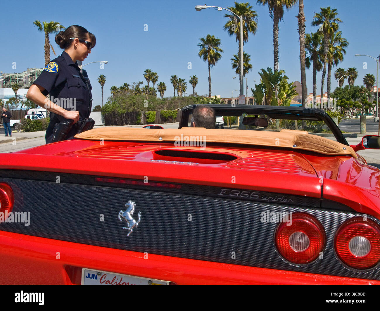 Female police officer addresses suspect driver in Ferrari Stock Photo ...