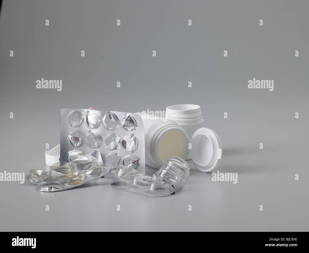 Waste pharmaceutical packaging with white plastic pill bottles shot in ...