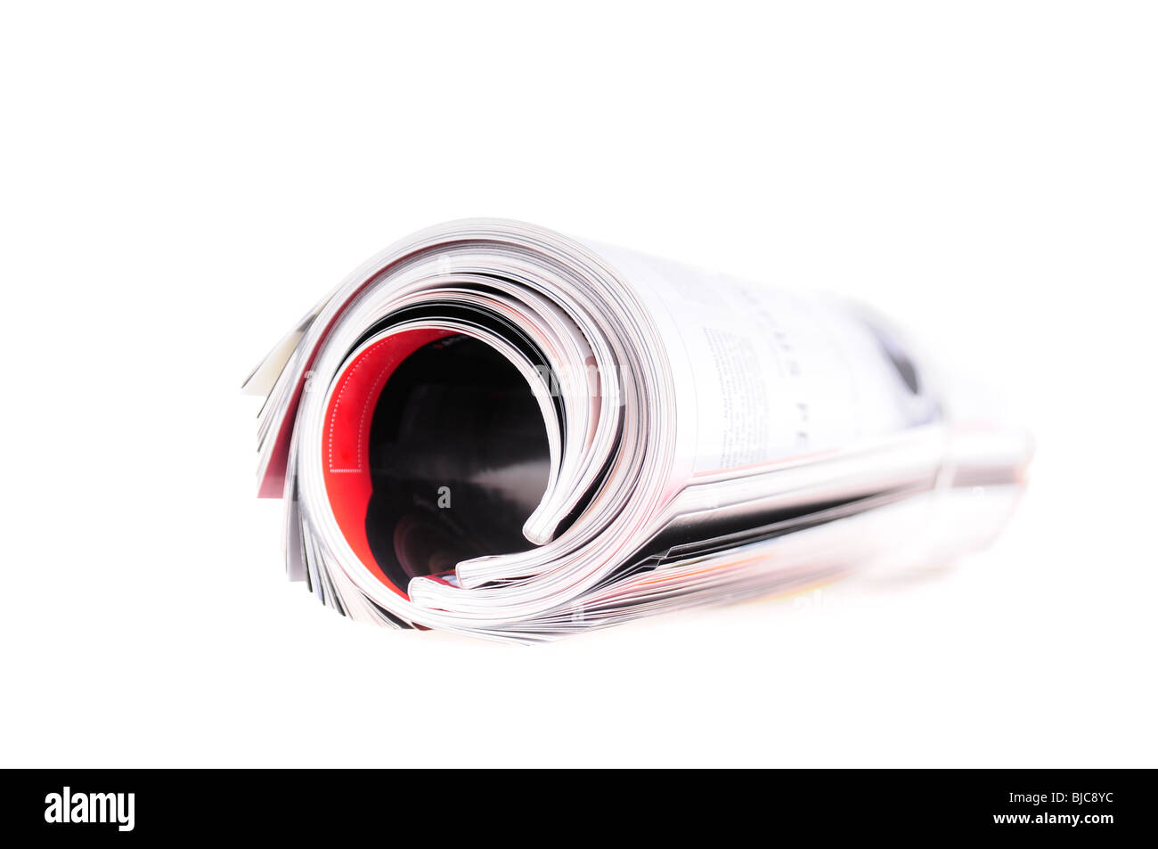 Rolled up newspaper isolated on the white background Stock Photo - Alamy