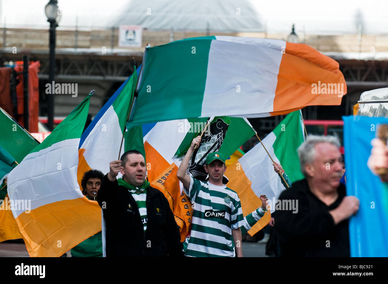 People waving Irish flags during the St patricks Day Parade in London ...