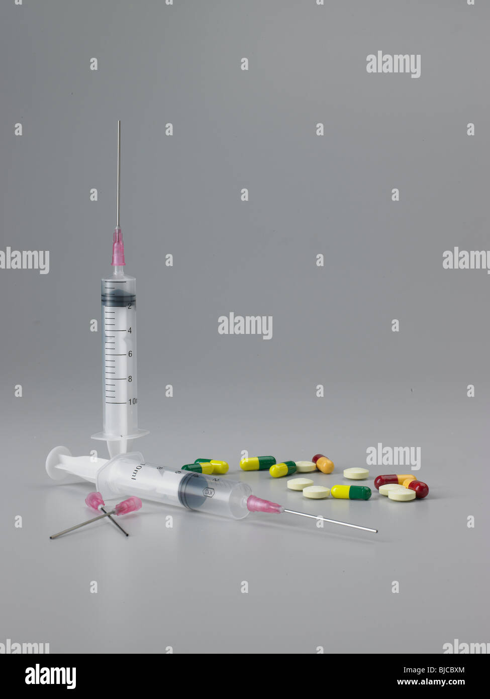 Syringes and needles with capsules and tablets low shot with spare ...
