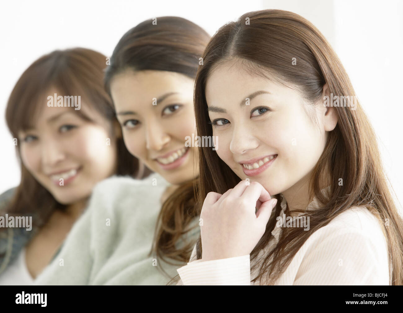 Young women smiling Stock Photo - Alamy