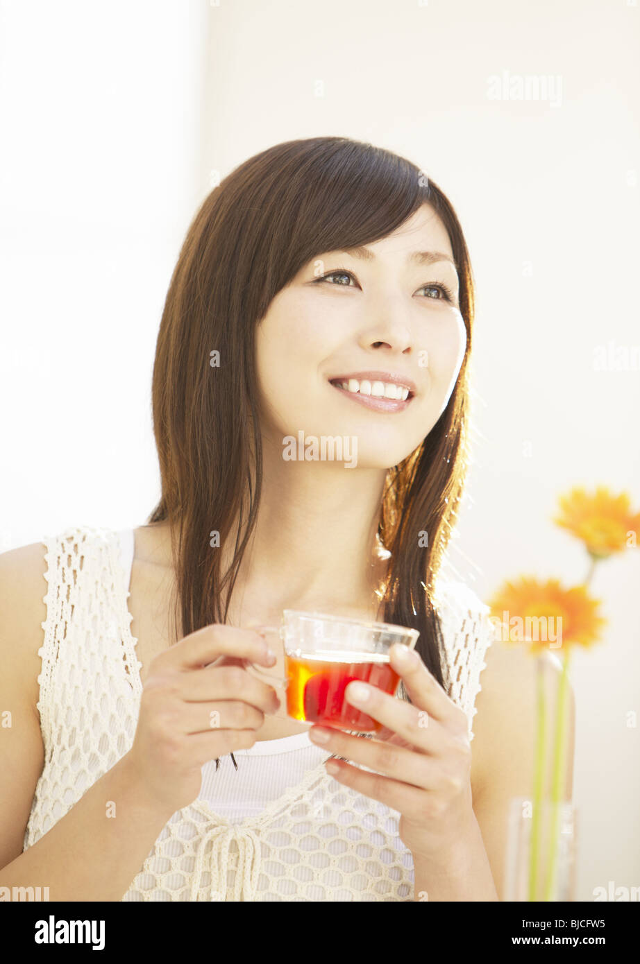A young woman drinking tea Stock Photo - Alamy