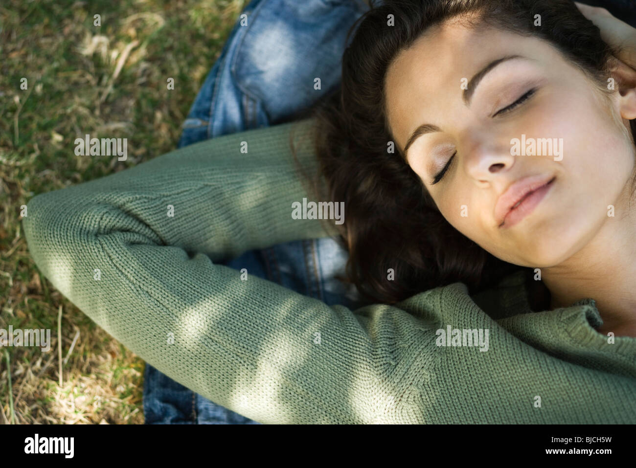 Woman taking nap on grass hi-res stock photography and images - Alamy
