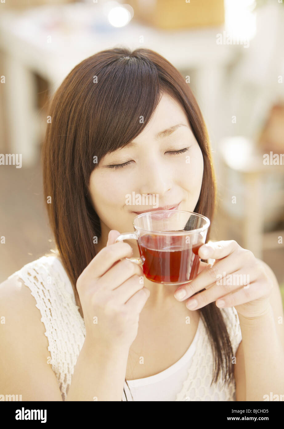 A young woman drinking tea Stock Photo - Alamy