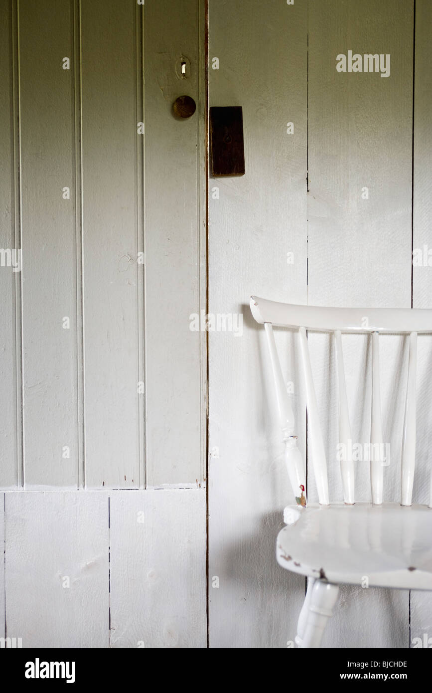 Chair by door Stock Photo - Alamy
