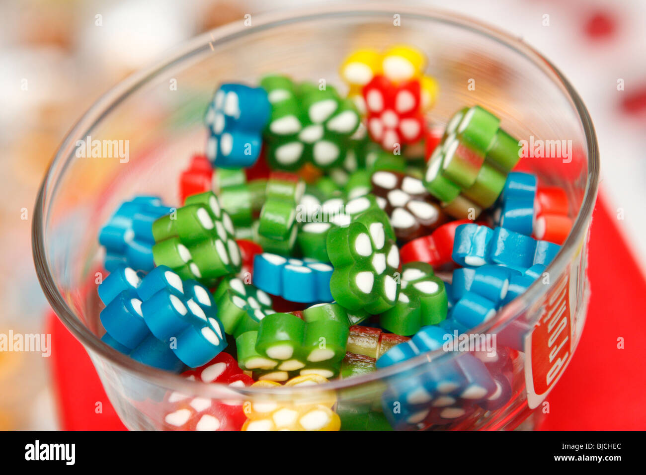 a flower shape candy sweets in transparent bowl Stock Photo - Alamy