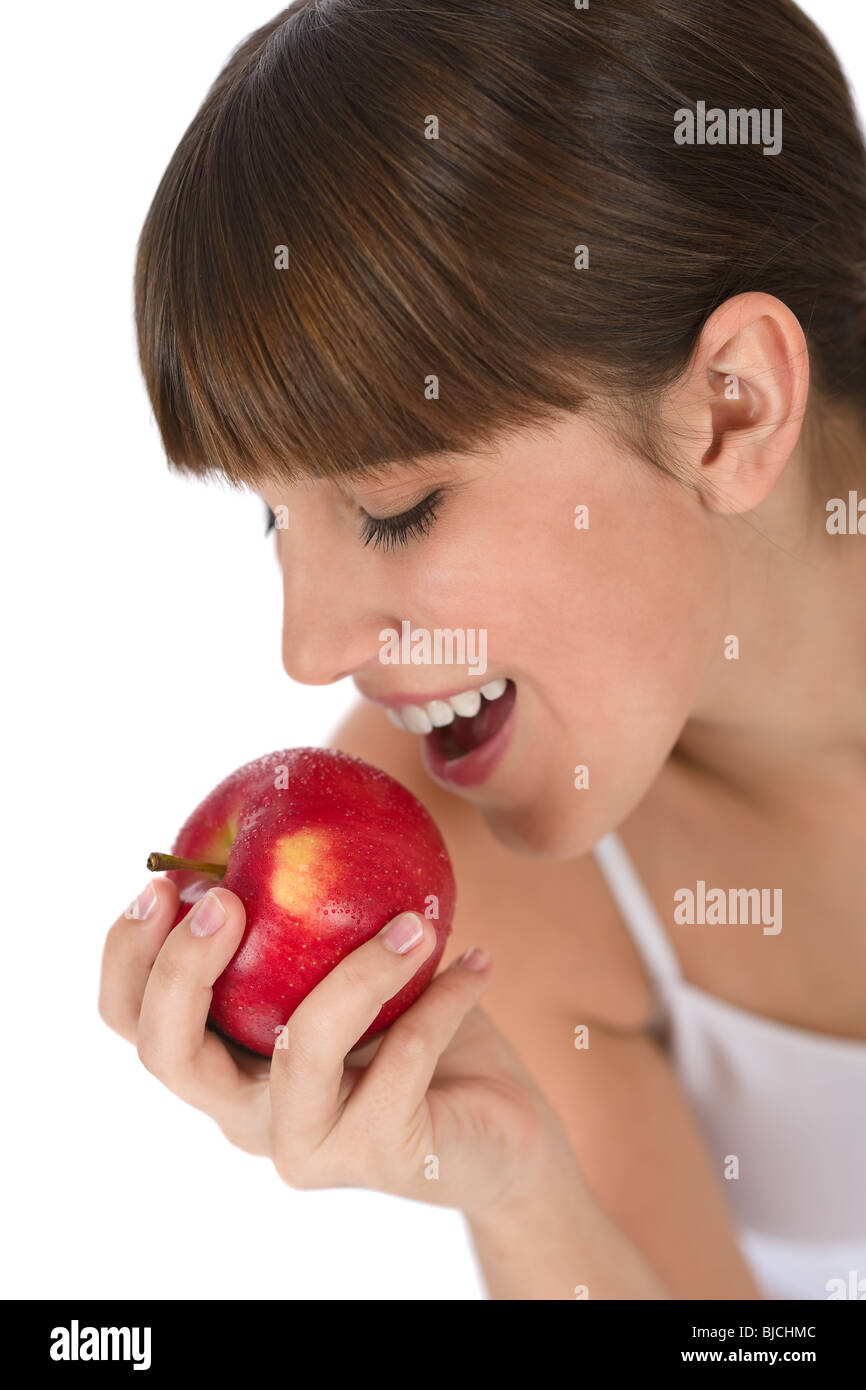 Female teenager eat apple for breakfast on white background Stock Photo ...