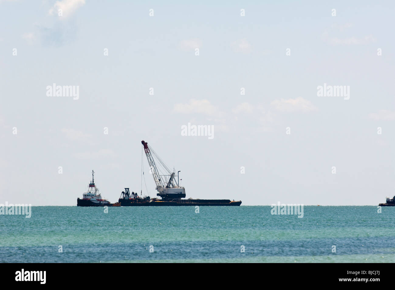 Tugboat pulling barge Stock Photo - Alamy