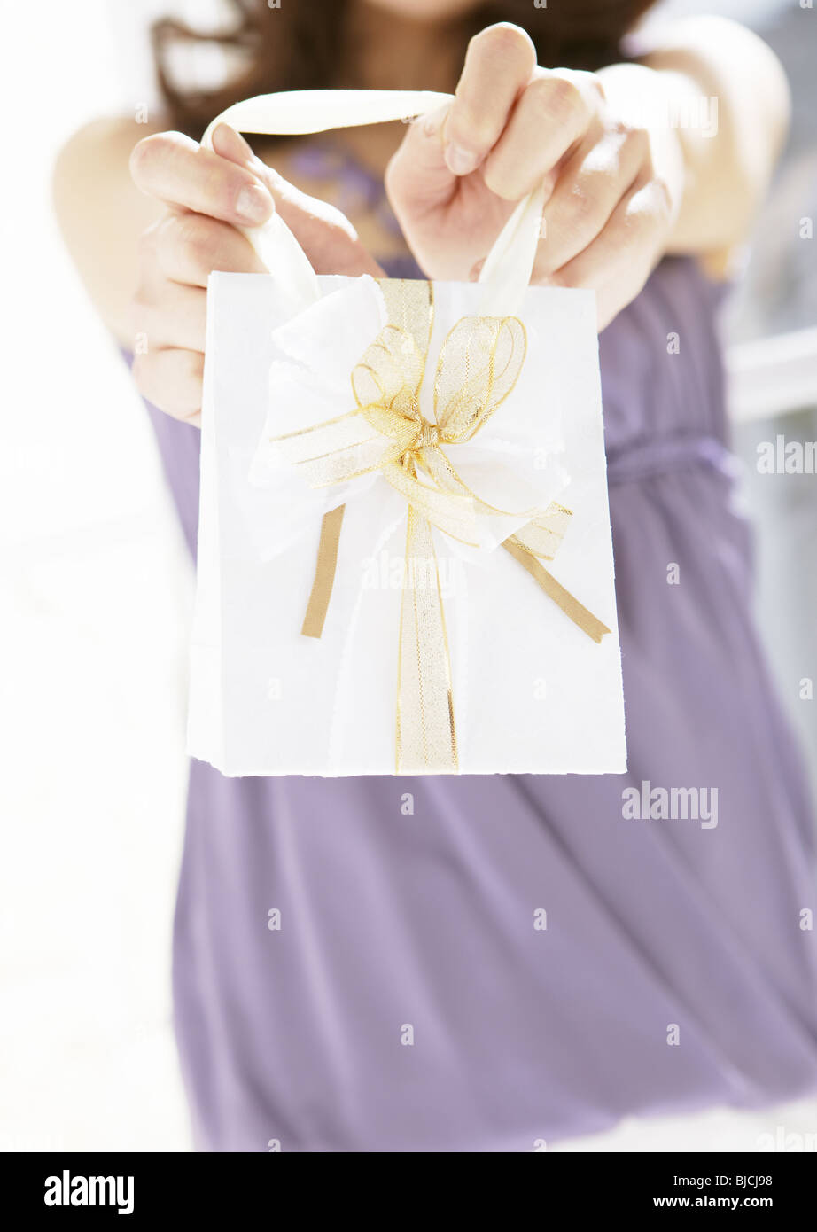A woman giving a gift Stock Photo - Alamy
