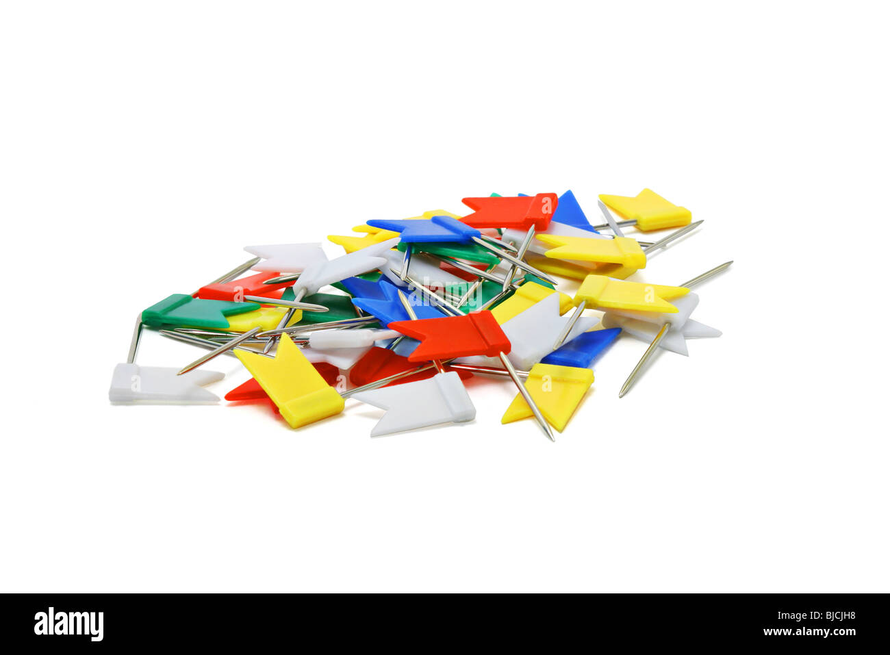 Scattered multicoloured flag shape push pins isolated on white ...