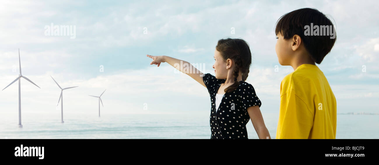 Children pointing to wind turbines in distance Stock Photo - Alamy