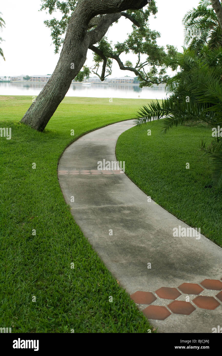 Paved path in waterside park Stock Photo - Alamy