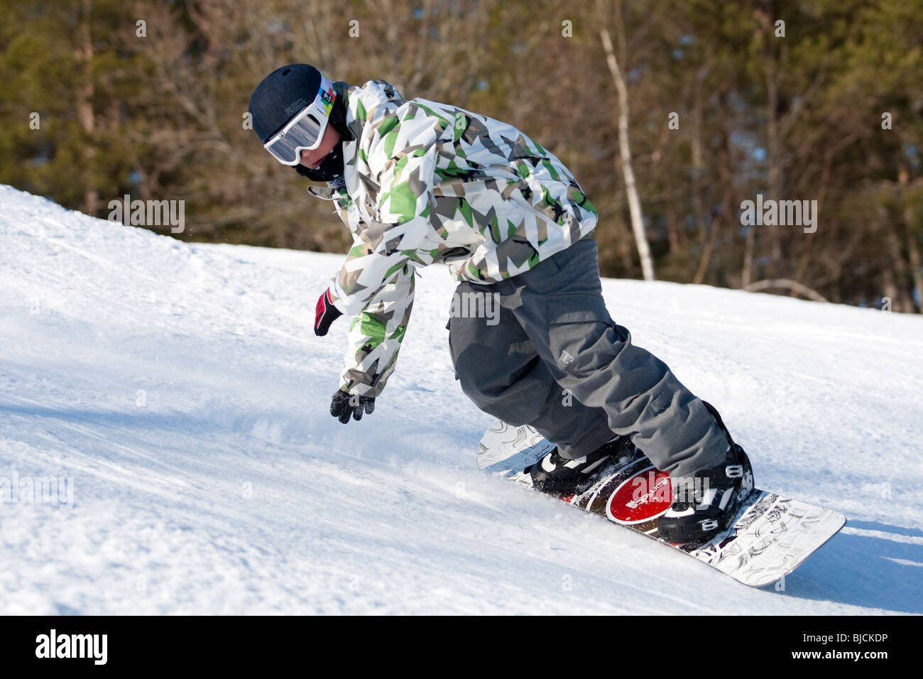 Kid on snowboard in ski slope Stock Photo - Alamy