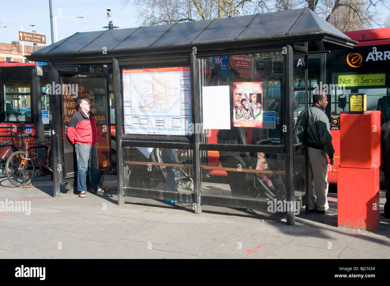 UK PASSENGERS WAITING FOR BUS IN TOTTENHAM LONDON Stock Photo - Alamy