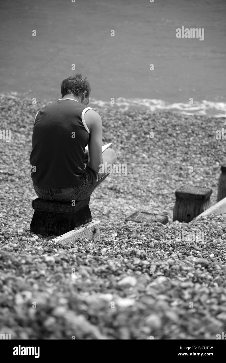 person sat on beach Stock Photo - Alamy