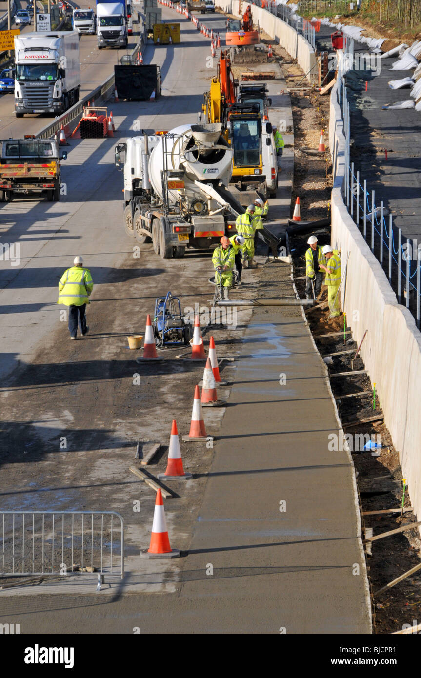 Civil Engineering road works construction workers & machines working ...