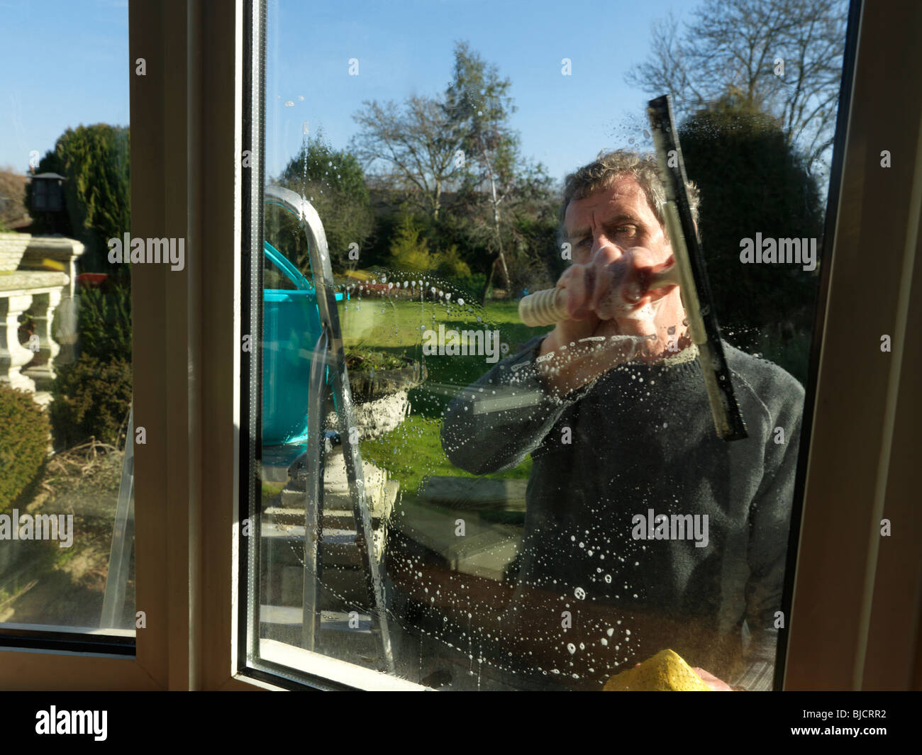 Cleaning windows with a squeegee hi-res stock photography and images ...
