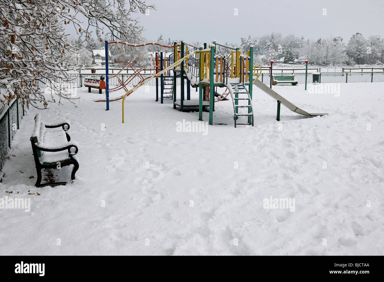 Colourful playground covered in snow Stock Photo - Alamy