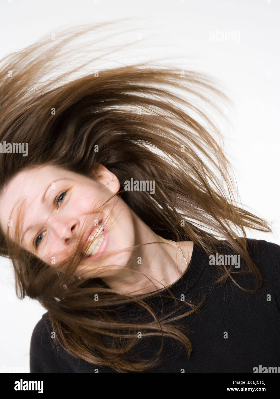 Woman flipping hair Stock Photo - Alamy