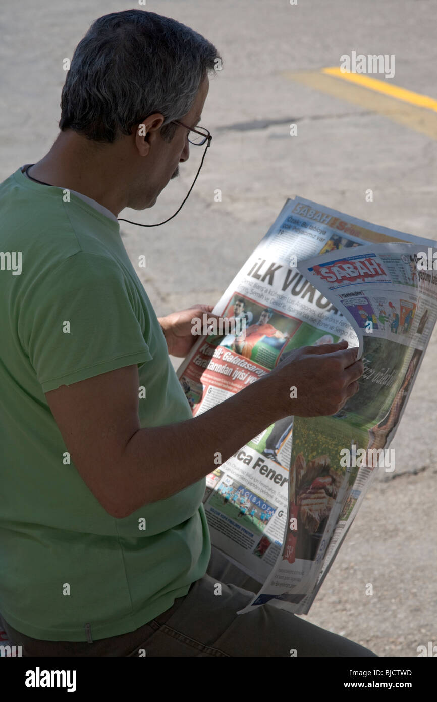 Man reading Tabloid Newspaper Bodrum Turkey Stock Photo - Alamy
