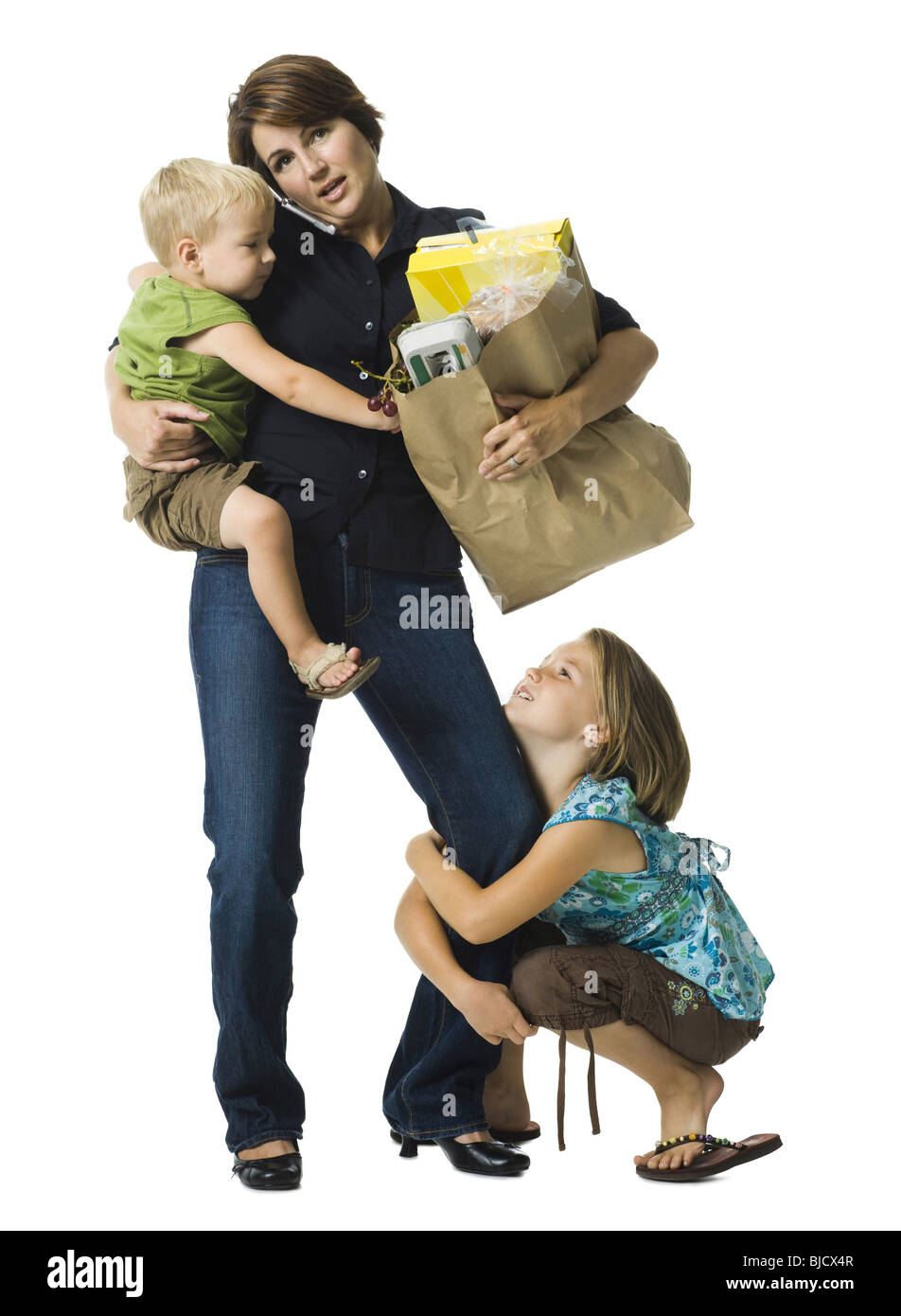 Busy Mom with baby and small child Stock Photo - Alamy