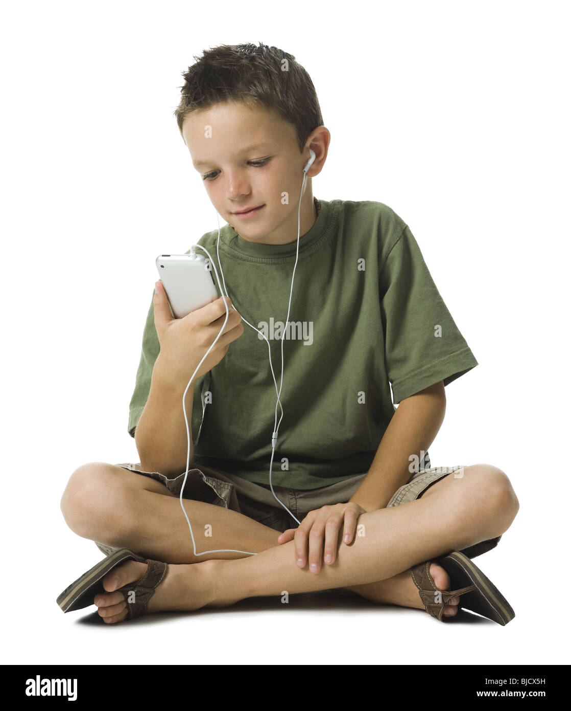 Boy listening to MP3 player Stock Photo - Alamy