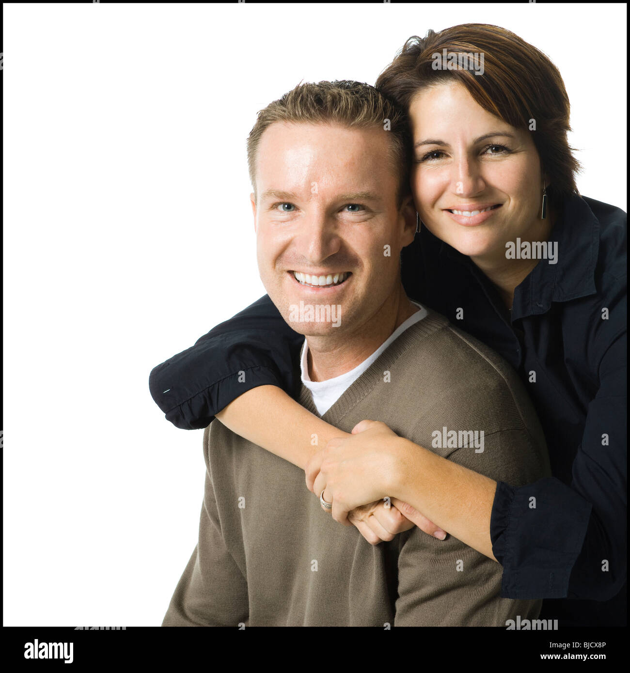 Couple with her arms around him Stock Photo - Alamy