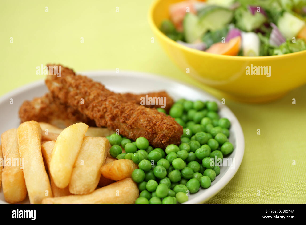 Deep Fried Fish Fingers With Chunky Potato Chips and Peas Served On A Plate Stock Photo - Alamy