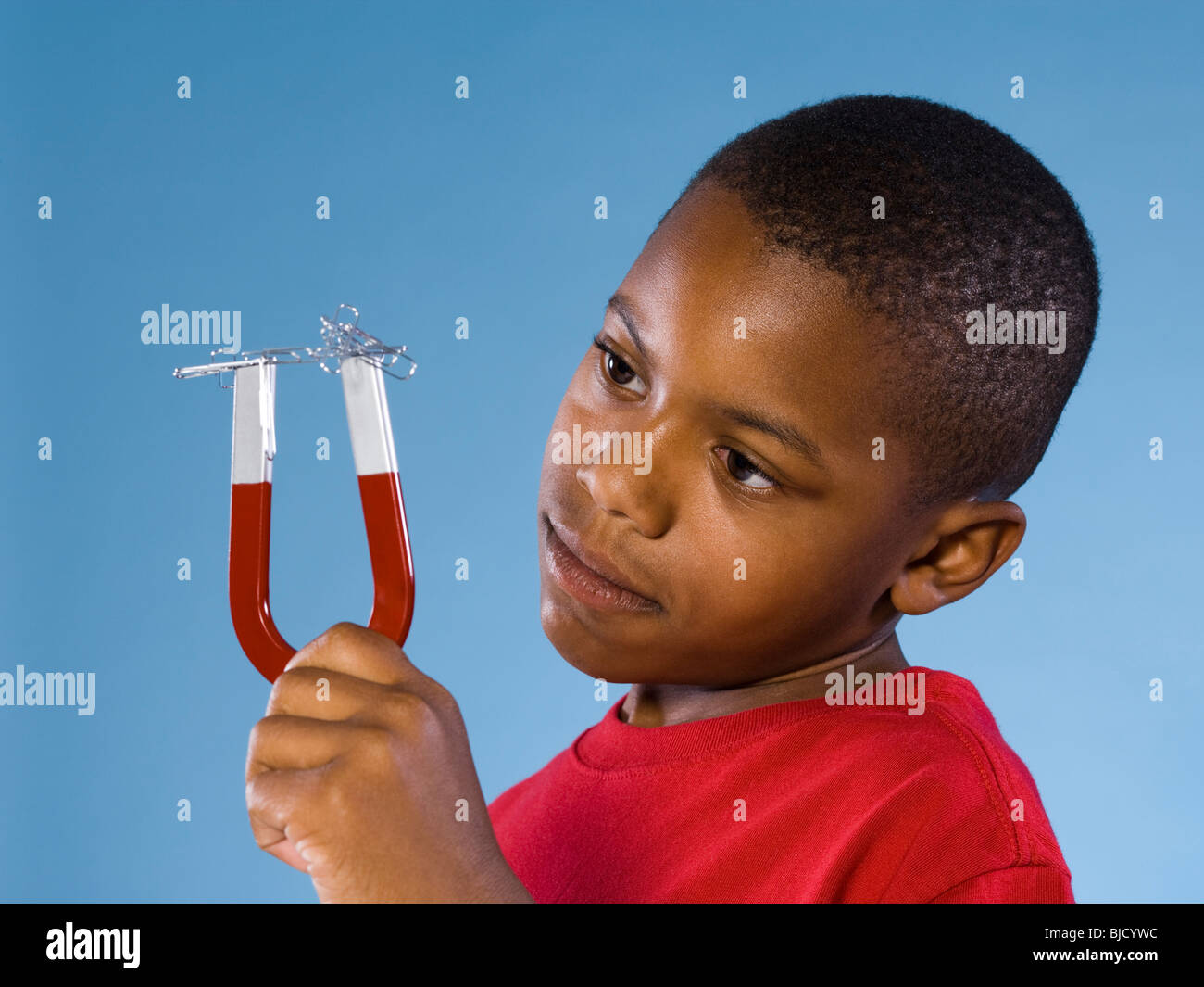 Child holding a magnet Stock Photo - Alamy