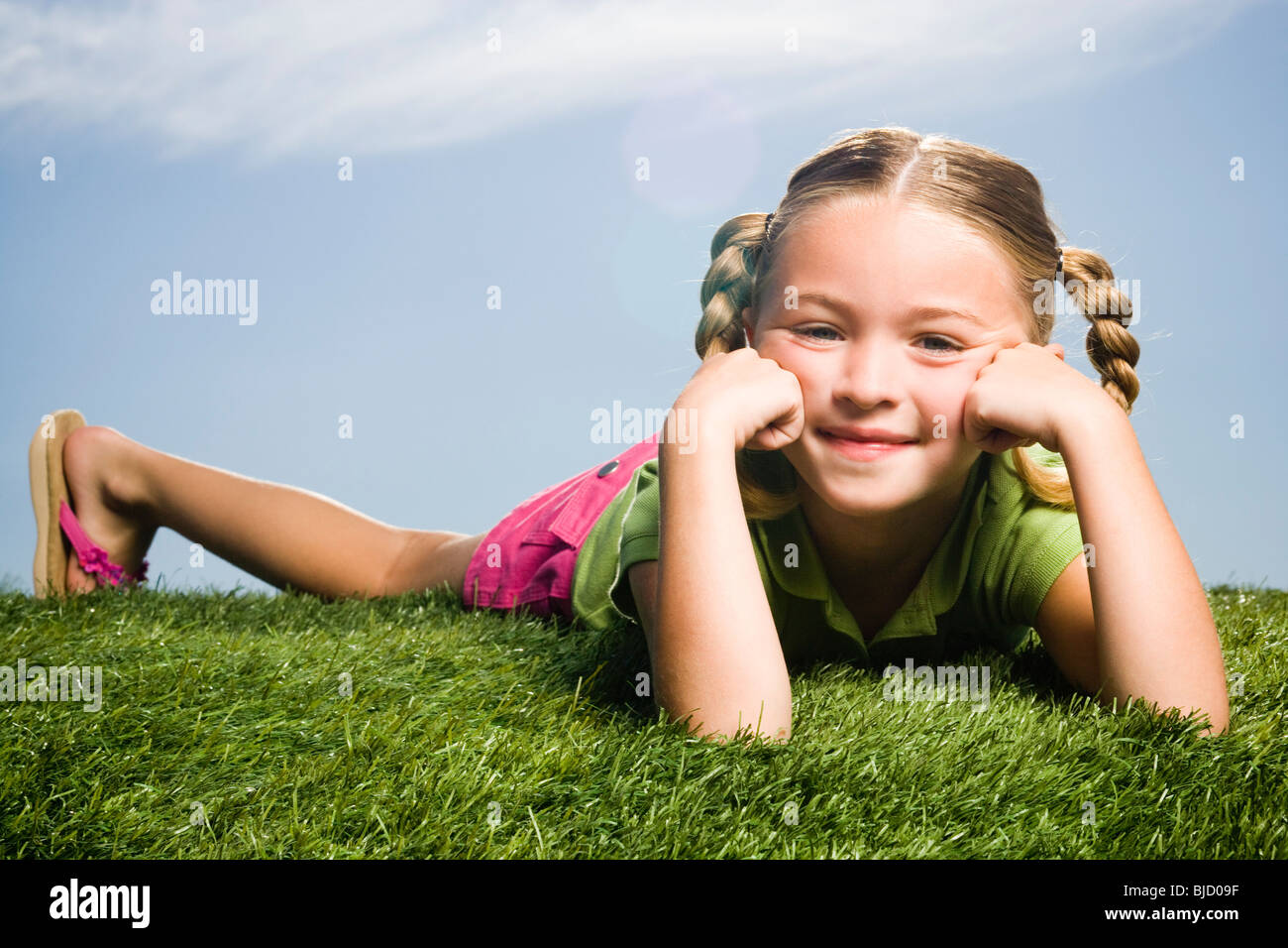 Young girl on the grass Stock Photo - Alamy