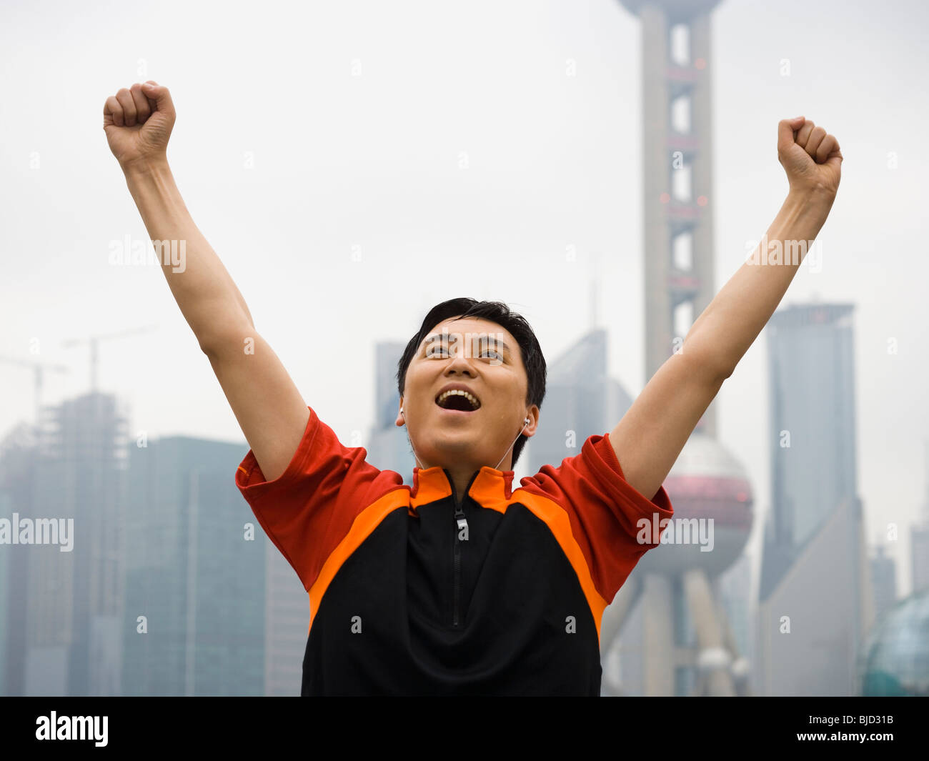 Man raising arms in the air Stock Photo - Alamy