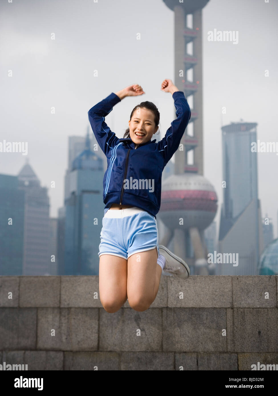 Woman raising arms in the air Stock Photo - Alamy