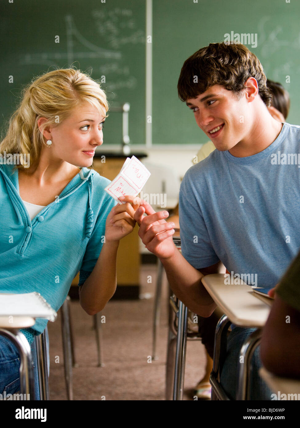 Students passing notes in a classroom Stock Photo - Alamy