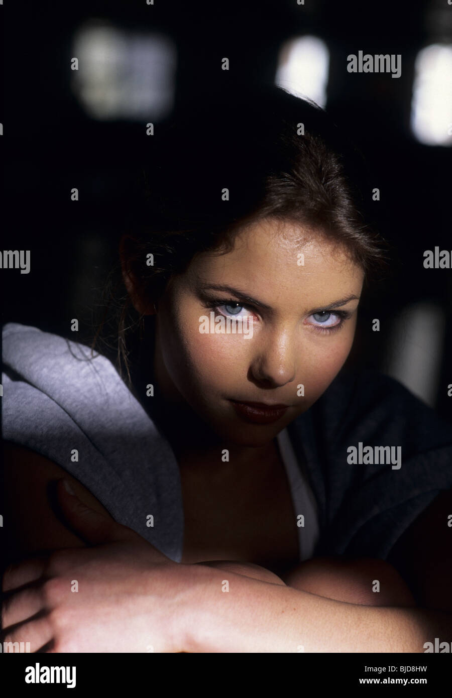 women in shadow in gymnasium with towel over shoulders Stock Photo - Alamy