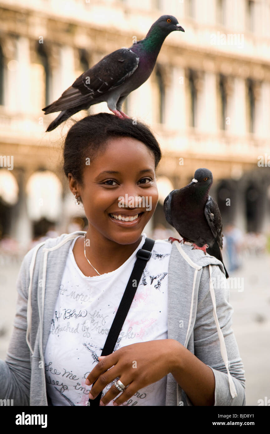Young woman with birds on her head and shoulder Stock Photo - Alamy