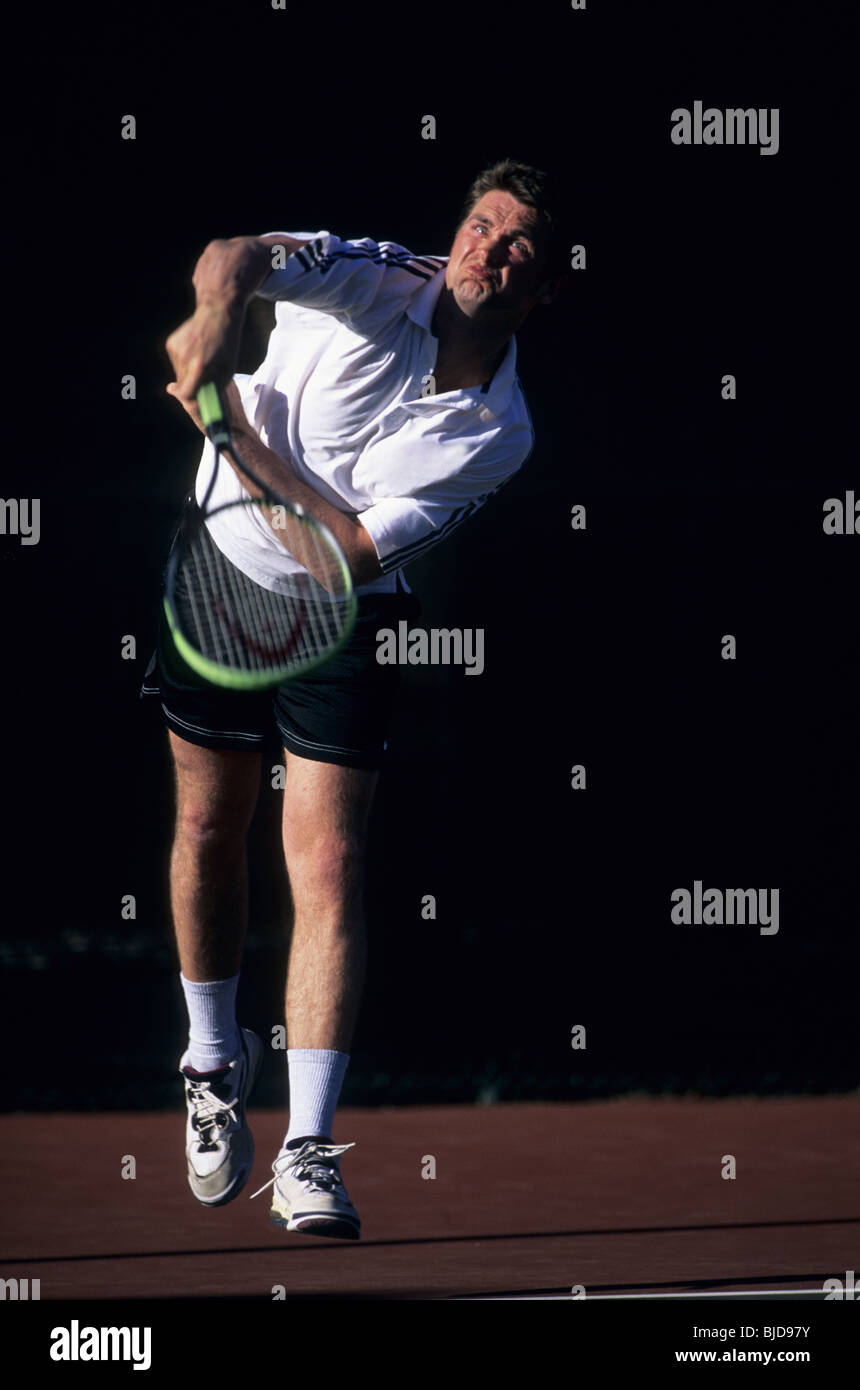 Tennis player in action on a hard court Stock Photo - Alamy