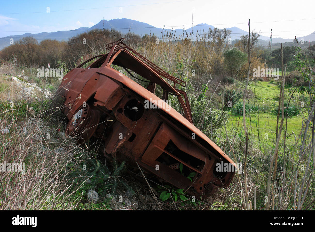 Burnt out and rusty car left at the roadside, Tirei, Italy Stock Photo ...