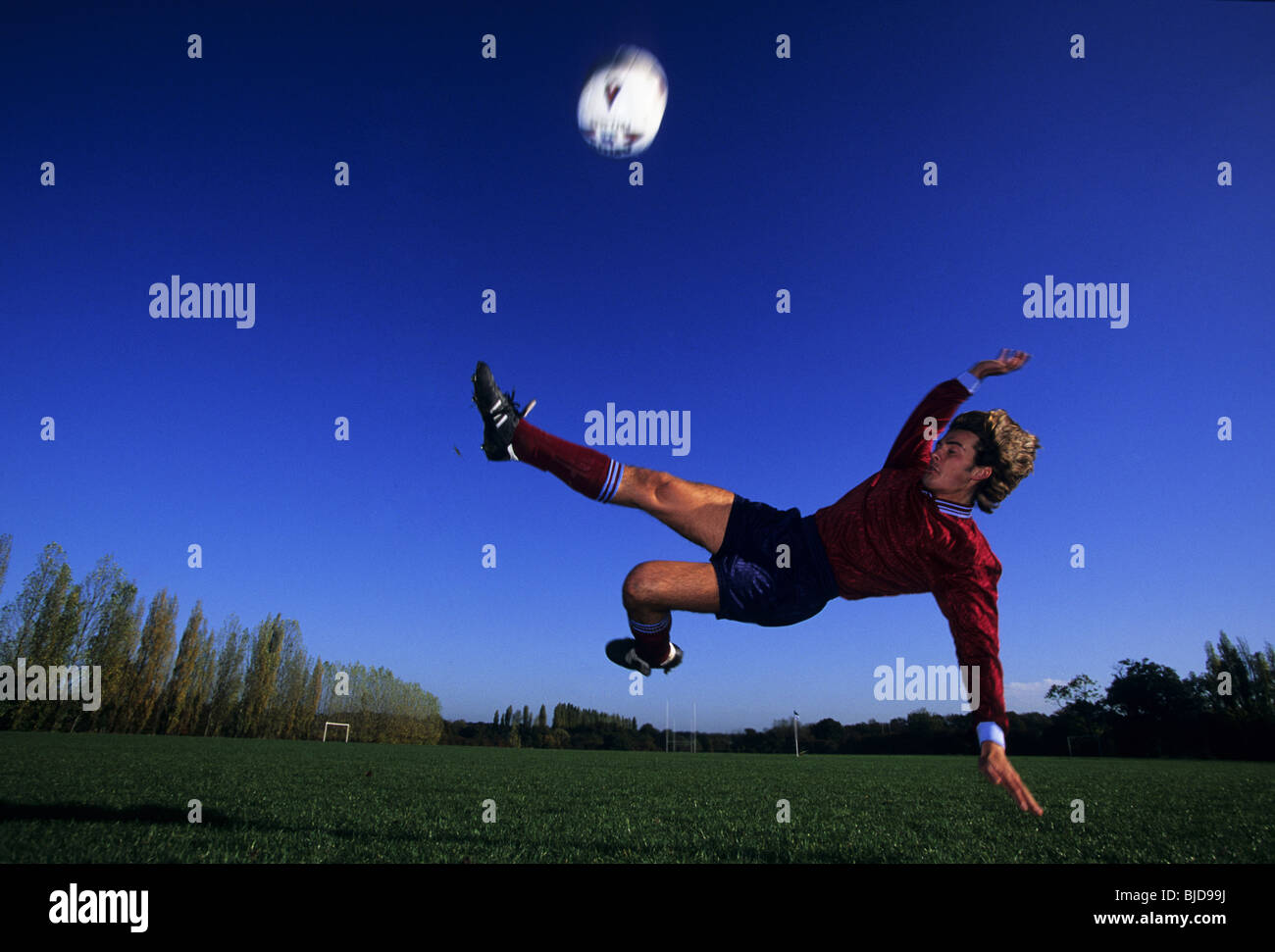 Soccer player performing bicycle kick Stock Photo - Alamy