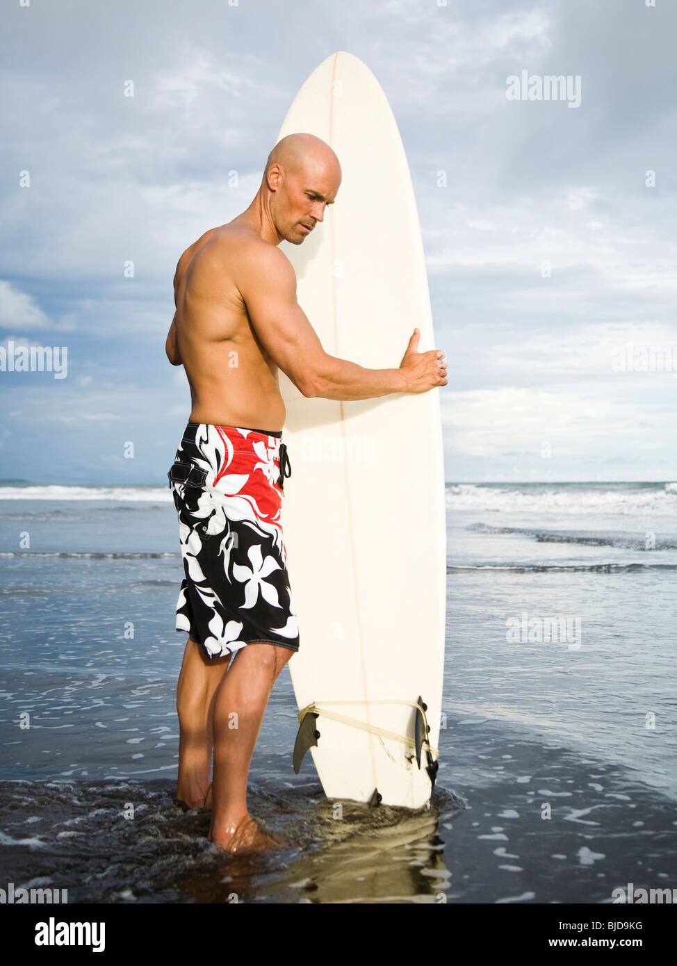 Man holding a surfboard Stock Photo - Alamy