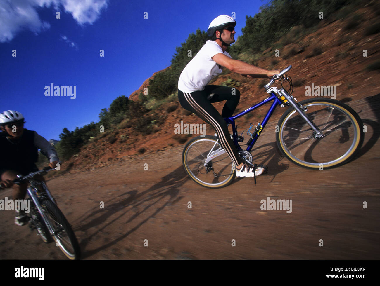 Two mountain bikers in action on off-road trail Stock Photo - Alamy