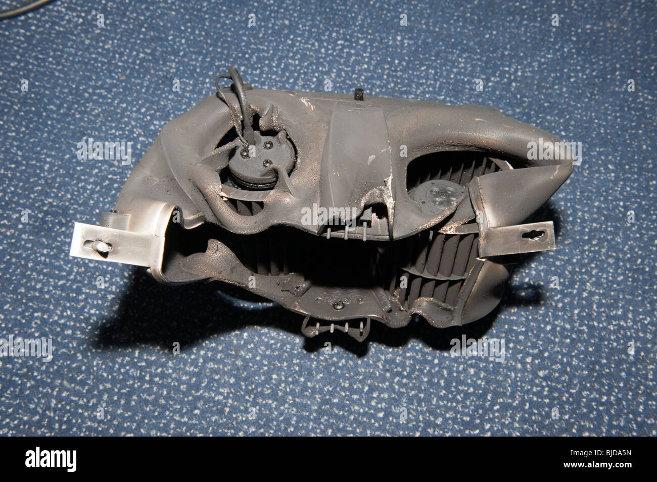 Burnt out air conditioning fan following fire in unit Stock Photo - Alamy