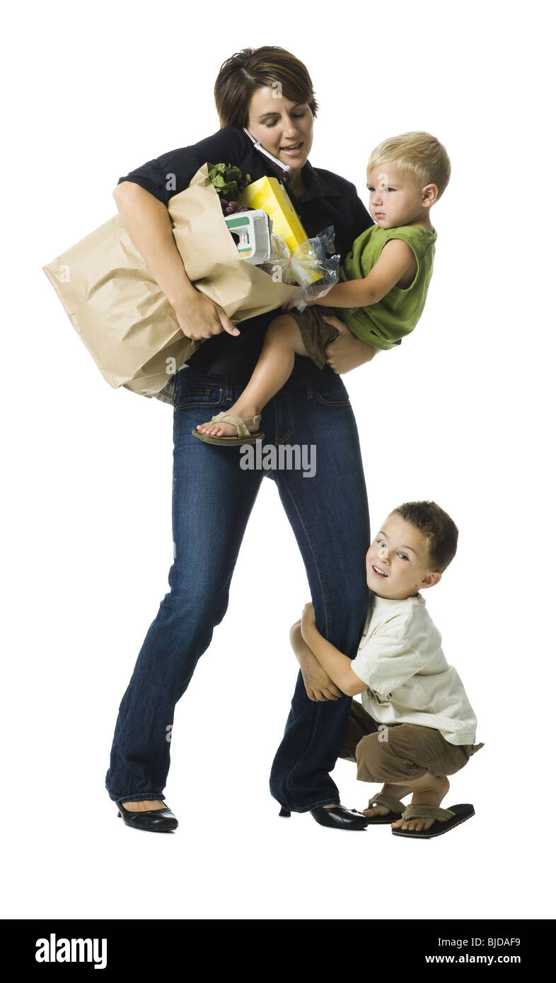 Busy Mom with baby and small child Stock Photo - Alamy