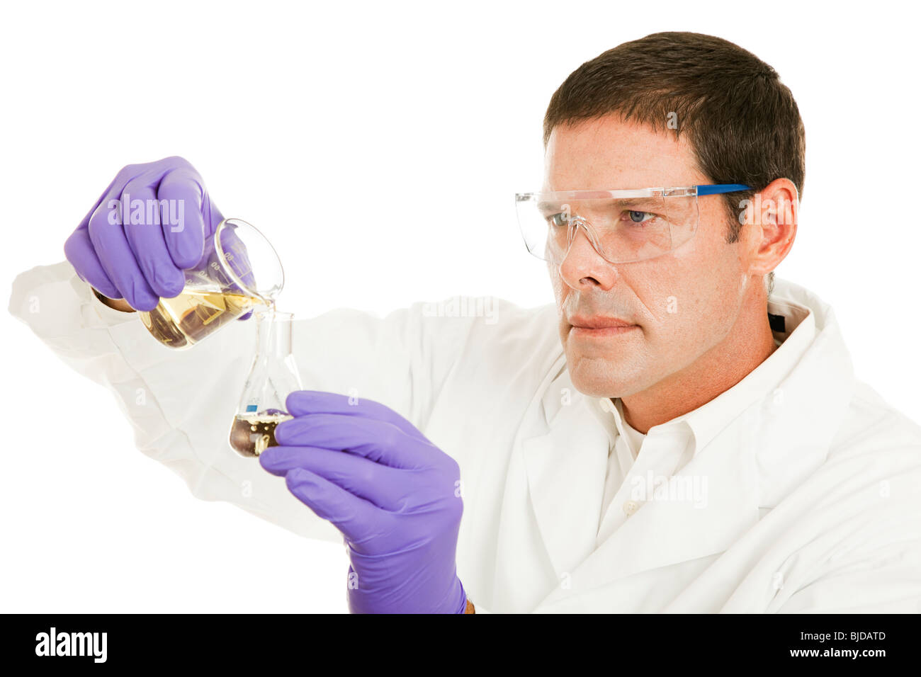 Scientist pours a chemical compound from a beaker to a flask. Isolated ...
