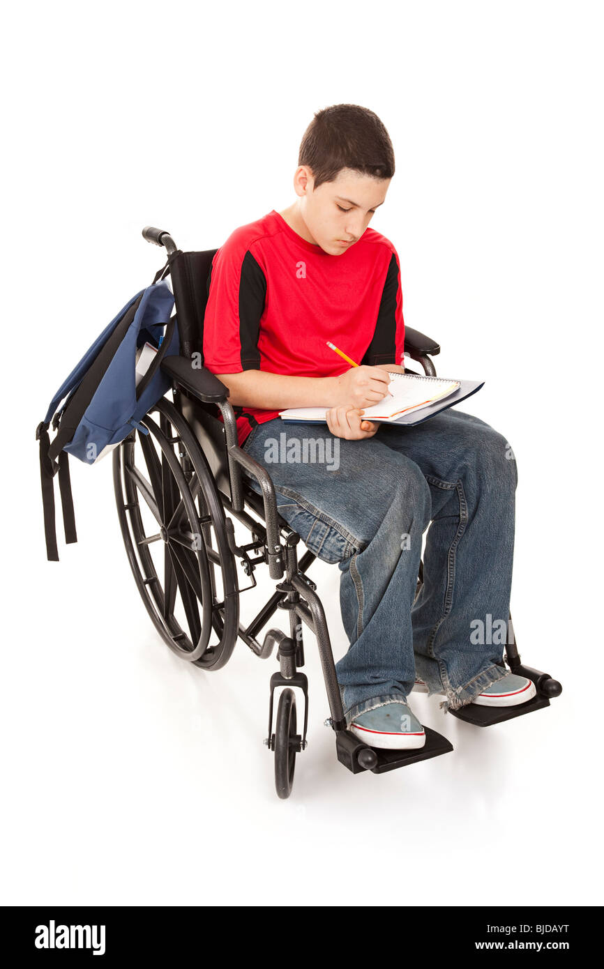 Disabled teenage boy doing homework in his wheelchair. Full body ...
